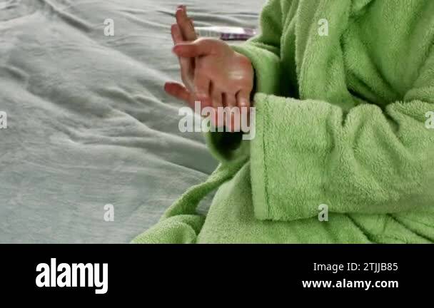 A woman lubricates her hands with cream and massages them. Womens hands ...