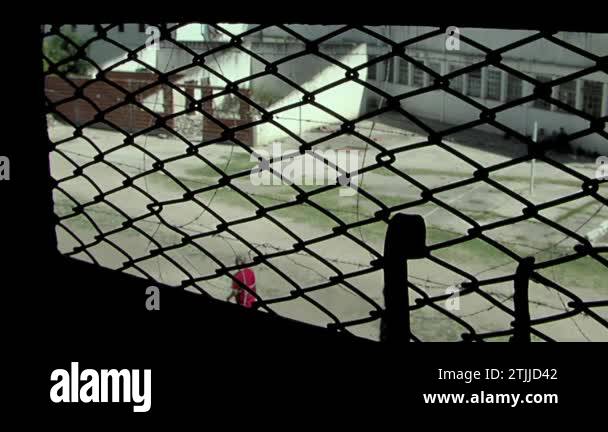 Window of Cell and Inmates playing Soccer in the Yard at Olmos Maximum ...