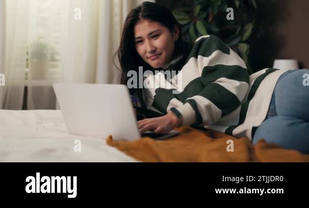 Happy young woman consumer holding credit card and laptop shopping ...
