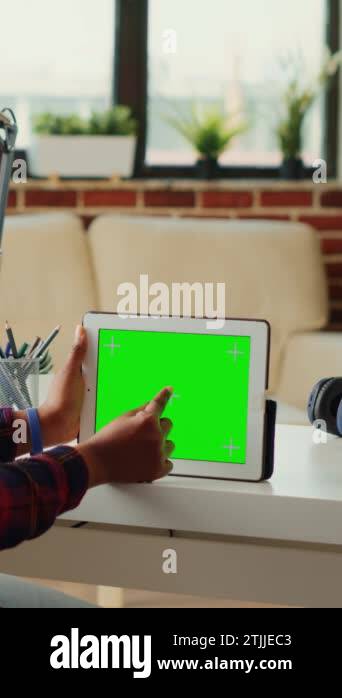 Vertical video: Office manager looking at horizontal greenscreen on ...