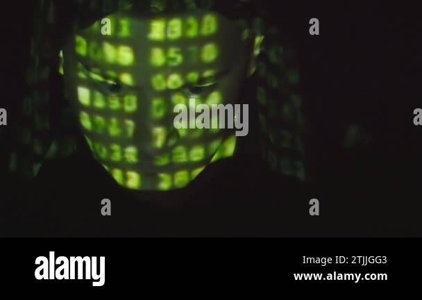 Source code projected over an angry hostile mans face, black background ...