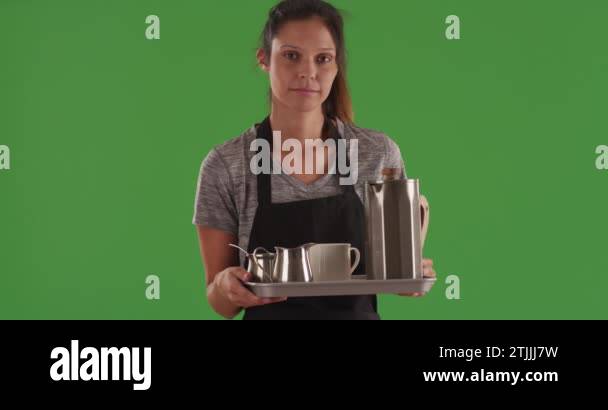Unhappy female server carrying tray with cup of coffee on greenscreen ...