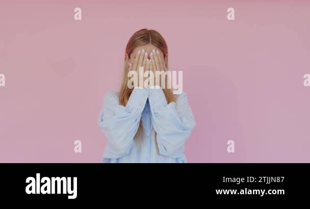 Young funny beautiful woman hiding face by hands and smiling. Happy ...