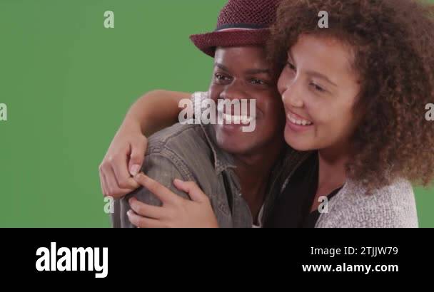 Young black man and woman hugging on green screen. On green screen to ...