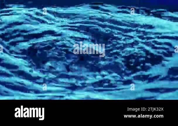 Bubbling water surface with air bubbles rising up. Blue transparent ...