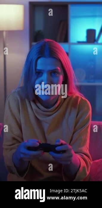 Vertical video. New play station. Expressive woman. Cyber fun. Happy ...