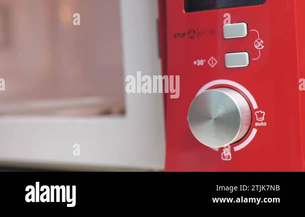 Heating food in the microwave. hand puts rice in microwave oven in ...