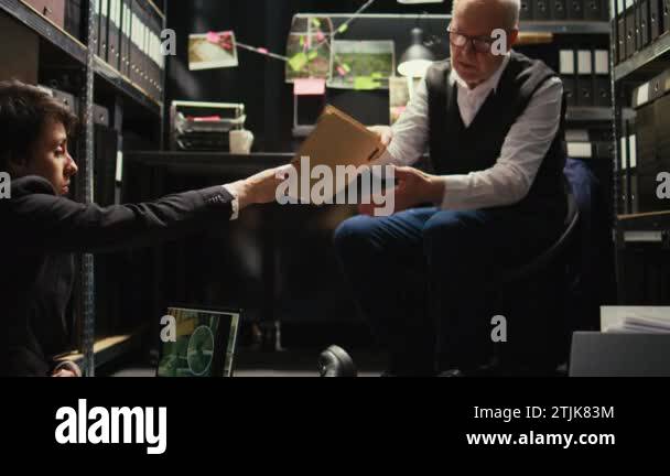 Two law agents examine case clues, doing teamwork to discover new ...