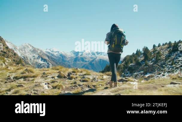 Handheld shot following female traveler on hike journey adventure with ...