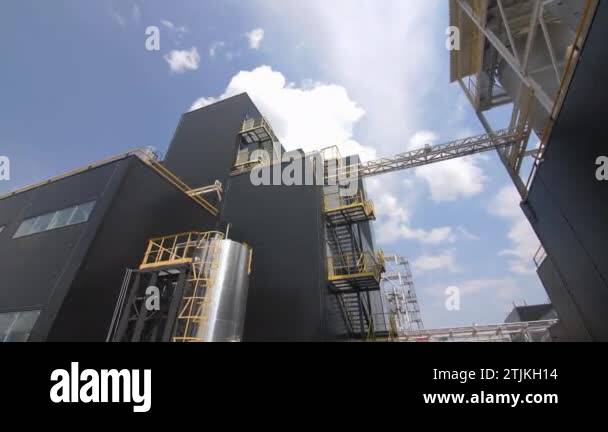 Metal cistern and service stairs near building of carbon fiber ...