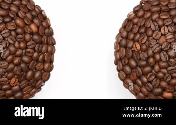 Coffee beans hang in the air on a white background. Side view. Loop ...