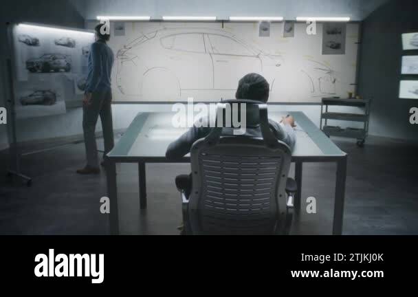 Two diverse automotive male designers developing sketch of futuristic ...