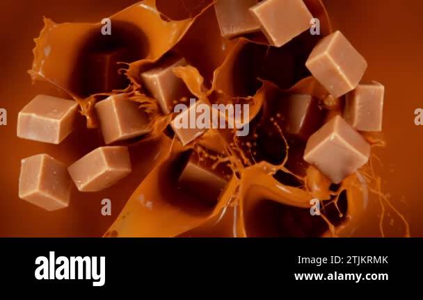 Super Slow Motion Shot of Caramel Chunks Falling into Melted Caramel at ...