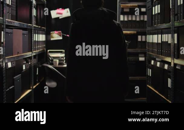 Law expert analyzing board with clues in police incident room, reading ...