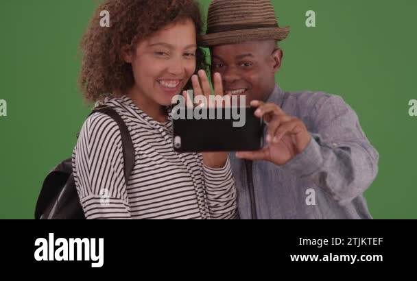Young black couple celebrate their engagement on green screen. On green ...