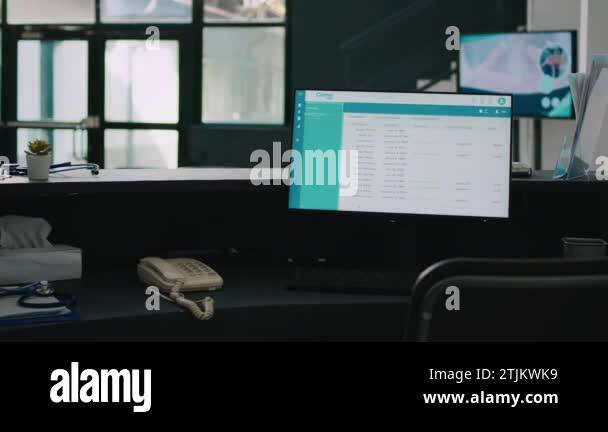 Hospital reception counter with computer showing appointments list ...