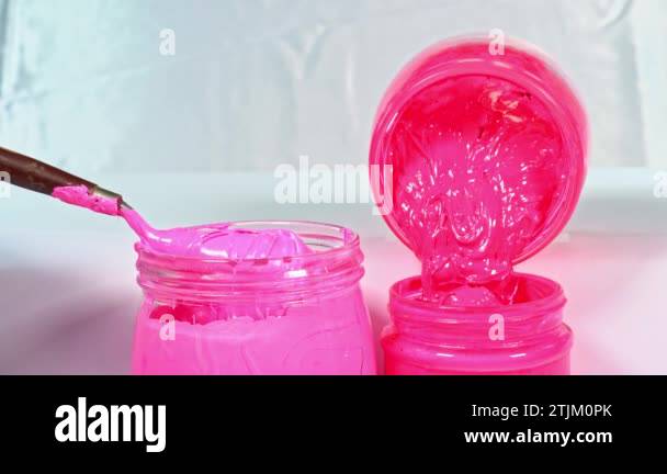 ..Use a trowel to soften the pink mix..Pink ink drips from the trowel ...