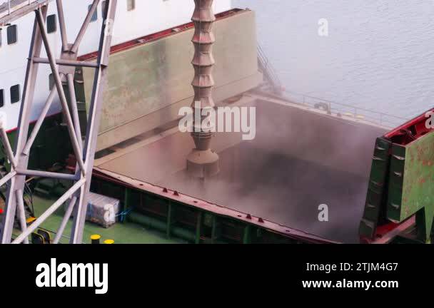 Wheat loading to bulker ship cargo container at sea grain terminal in ...