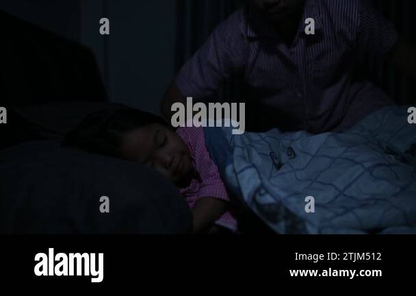 Dad and daughter sleep on the bed in bedroom, Watch cartoon with phone ...