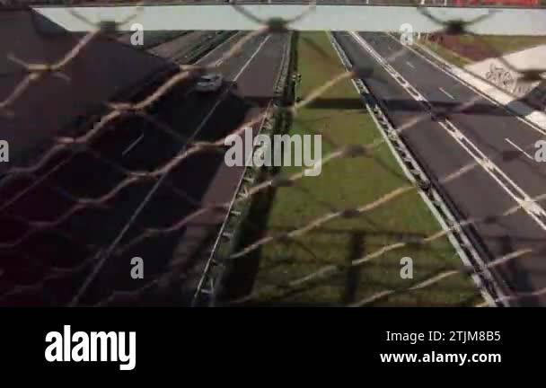 Walking along highway, rear view from above the overpass, vehicles ...