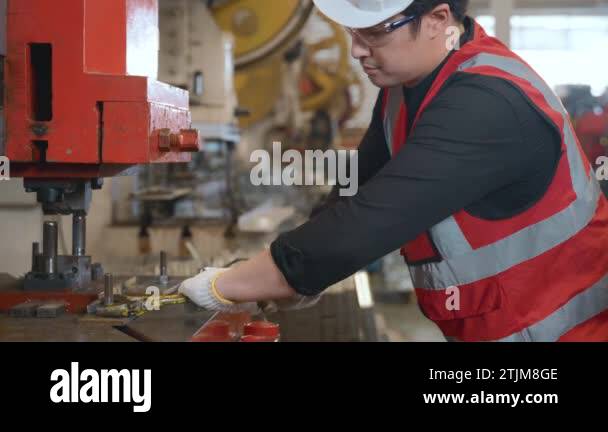 Worker man machine tightening nut, mechanic is repairing the machine ...