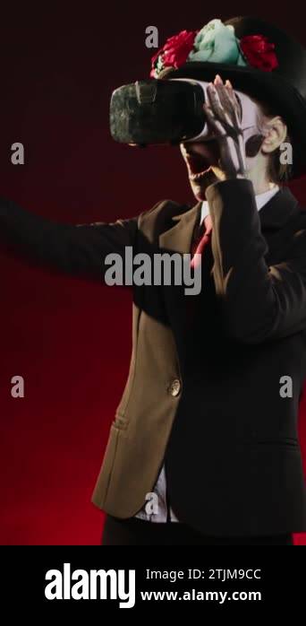 Vertical video: Beautiful scary woman holding virtual reality headset ...