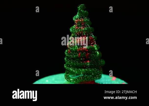 Christmas tree with blinking animation rotates on a black background ...