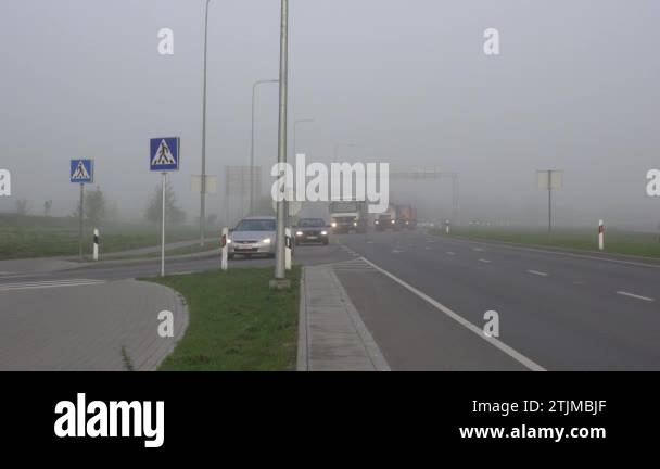 Cars traffic on city highway in heavy smog fog. Air pollution. 4K Stock ...