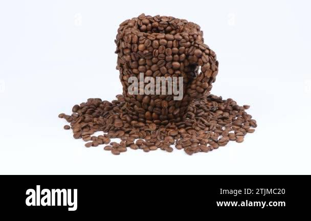 A cup made of coffee beans on white. Side view. Loop motion. Rotation ...