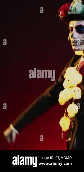 Vertical video: Horror model with costume of death dancing in studio ...