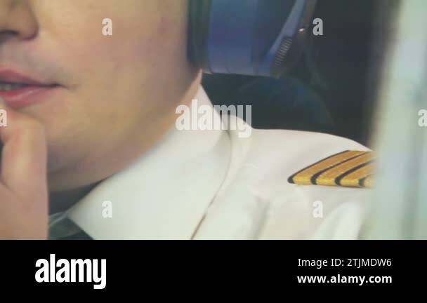 Airplane pilot talking over radio in cockpit, reporting situation to ...
