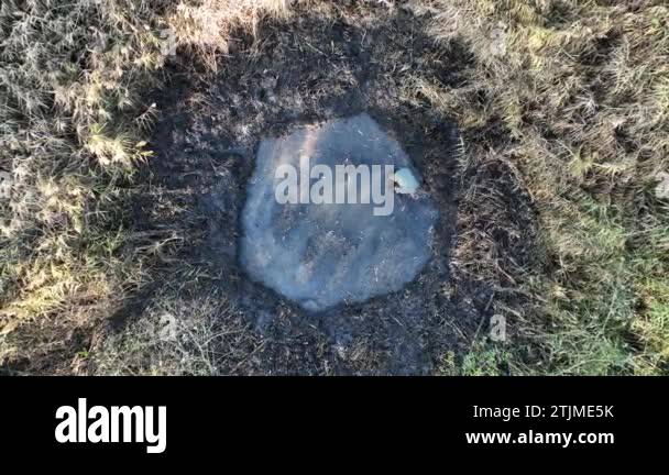 Puddle swamp dig spade worker man drone aerial puddle protection ...