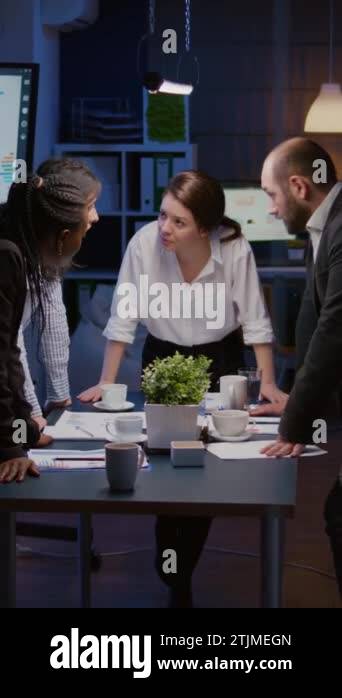 Vertical video: In corporate meeting room diverse multi ethnic group of ...