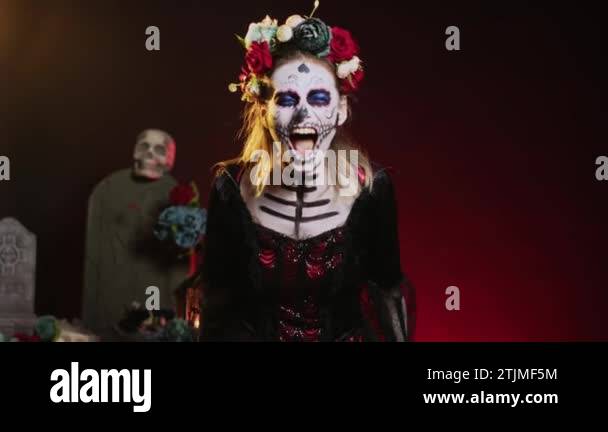 Scary dead woman screaming loud dressed in costume with skull body art ...