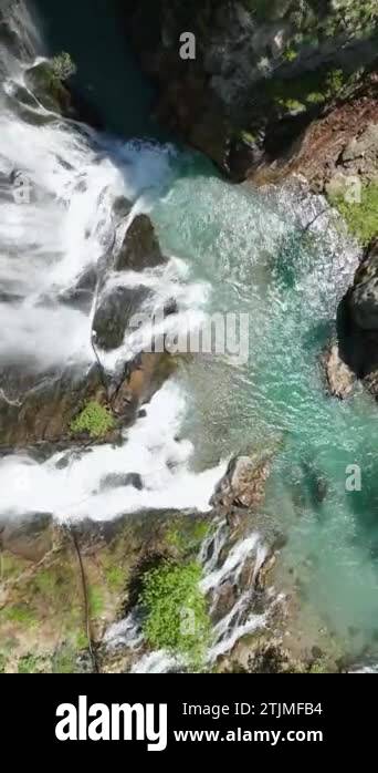 Discover the cinematic beauty of a magical waterfall with azure waters ...