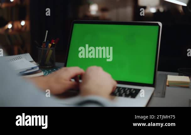Man hands typing chromakey laptop at remote workplace closeup. Unknown ...