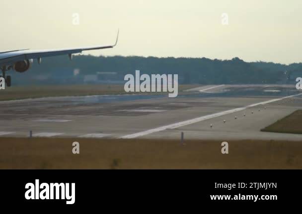 Rear view, unrecognizable jet plane silhouette landing and braking ...