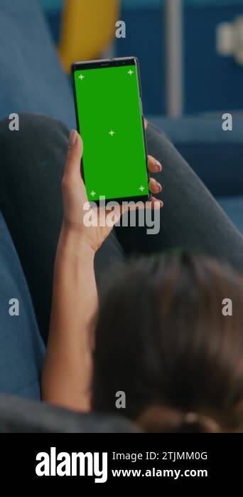 Vertical video: Freelancer lying on sofa while having online videocall ...
