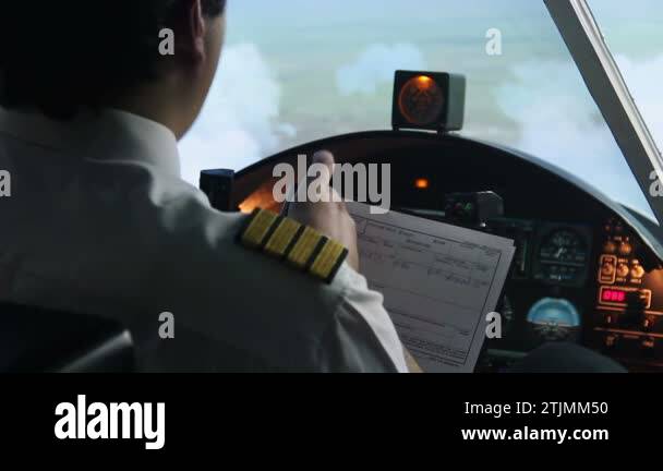 Pilot filling out flight documentation, plane flying in autopilot mode ...