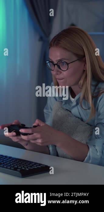 Vertical video. Game addiction. Competitive woman. Digital technology. Inspired lady playing on ...