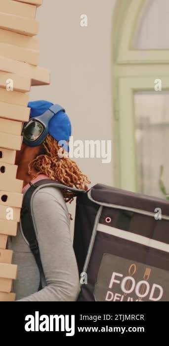 Vertical video: Reckless delivery worker dropping pizza boxes, scared ...