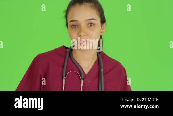 A doctor poses for a portrait on green screen. On green screen to be ...