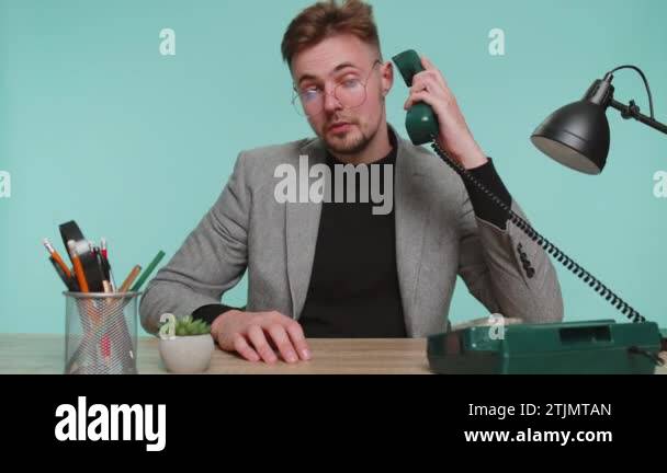 Hey you, call me back. Happy bearded business man sitting at office ...