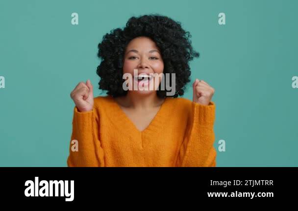 Slow motion excited African American woman with curly hair screaming ...