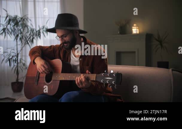 Male guitarist play song online learning using laptop.Man playing ...