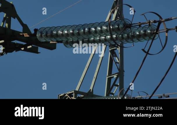 Power lines with sun rays on blue sky. High voltage substation ...