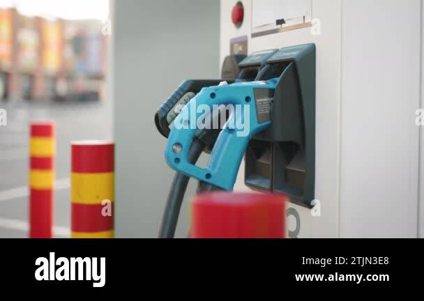 Electric charging station with blue and black power cords. Blurred ...