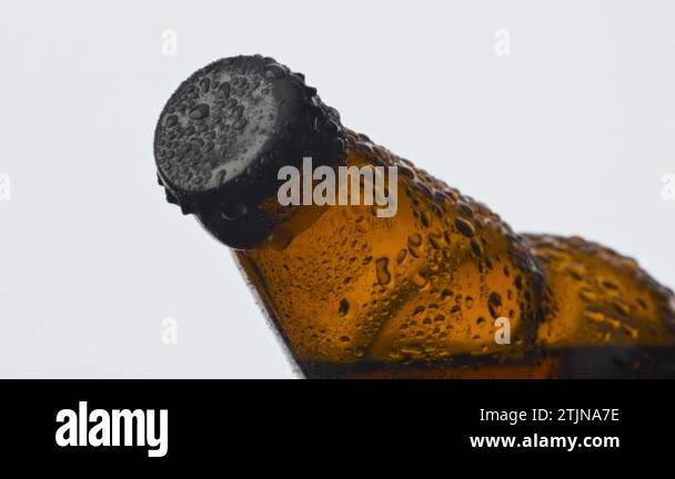 Brown condensate beer bottle closeup. Hoppy ipa beverage flask with ...