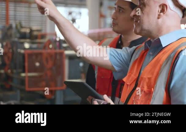 Two engineers talking together in roof steel metal manufacturing ...