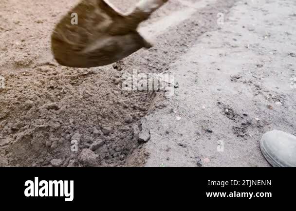 Digging up the garden with a shovel close-up. Plowing the soil of a ...